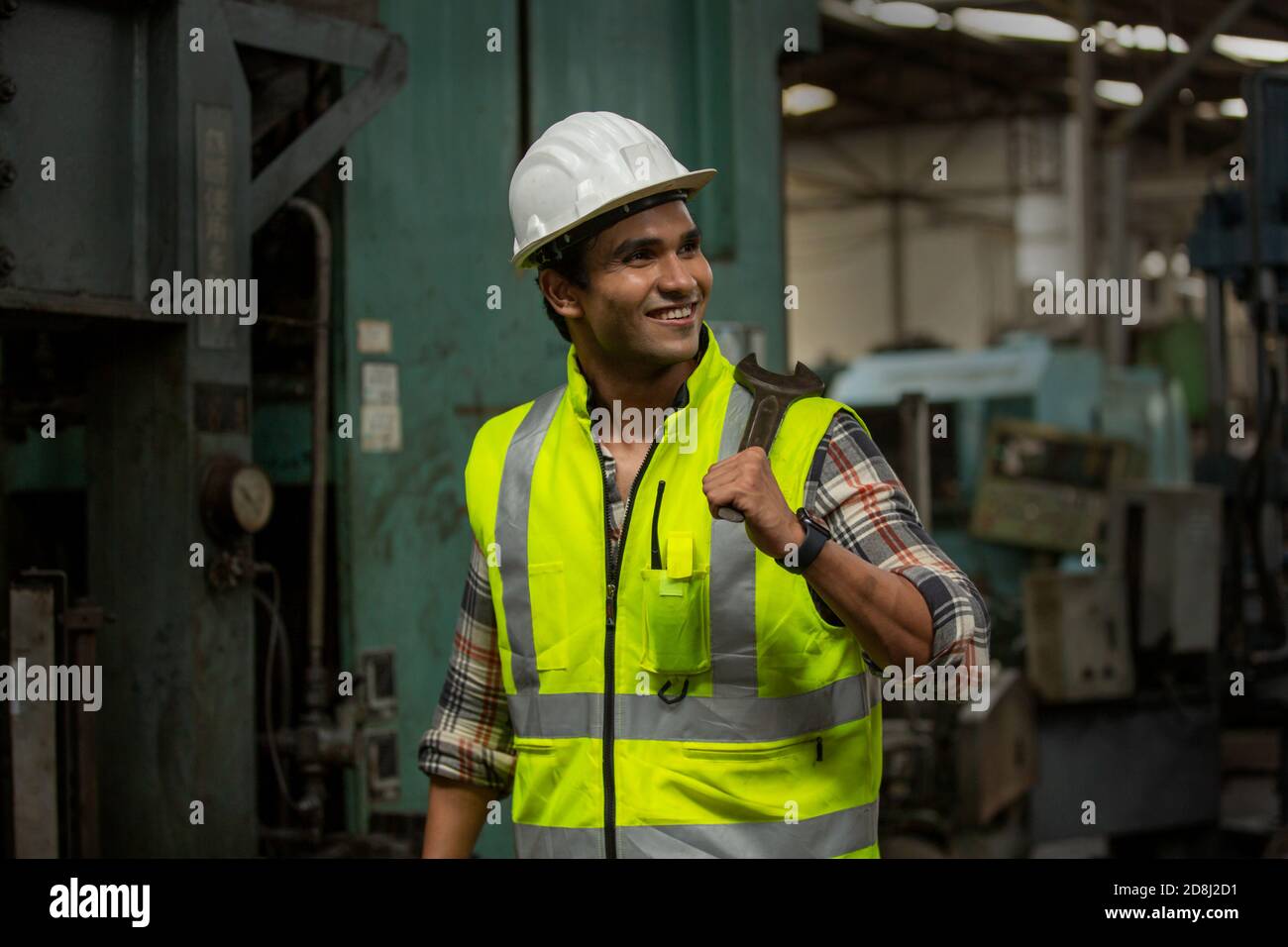 Engineers operating a cnc machine in factory Stock Photo - Alamy