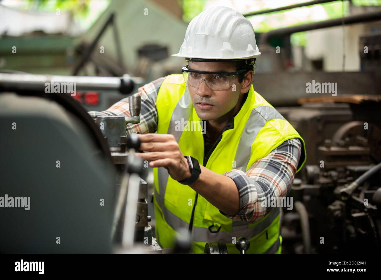 Engineers operating a cnc machine in factory Stock Photo - Alamy