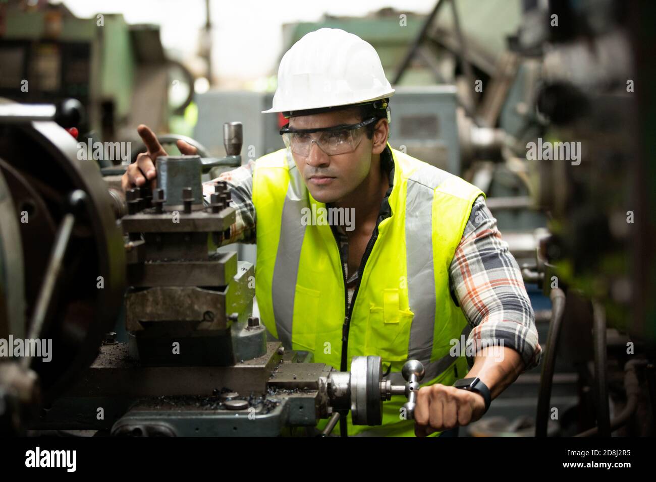 Engineers operating a cnc machine in factory Stock Photo - Alamy