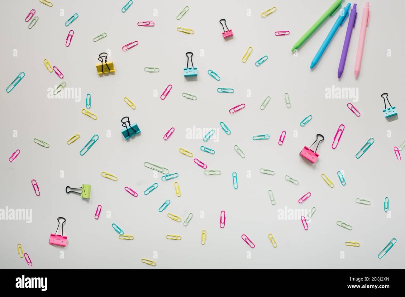rainbow office supplies flat lay on white background Stock Photo - Alamy