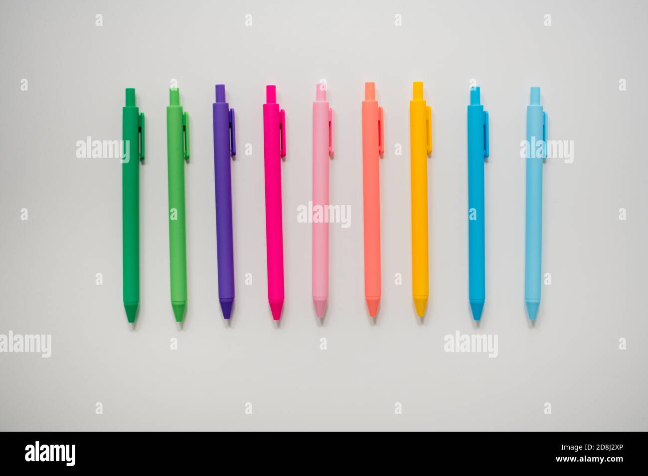 rainbow pens arranged on white background Stock Photo - Alamy