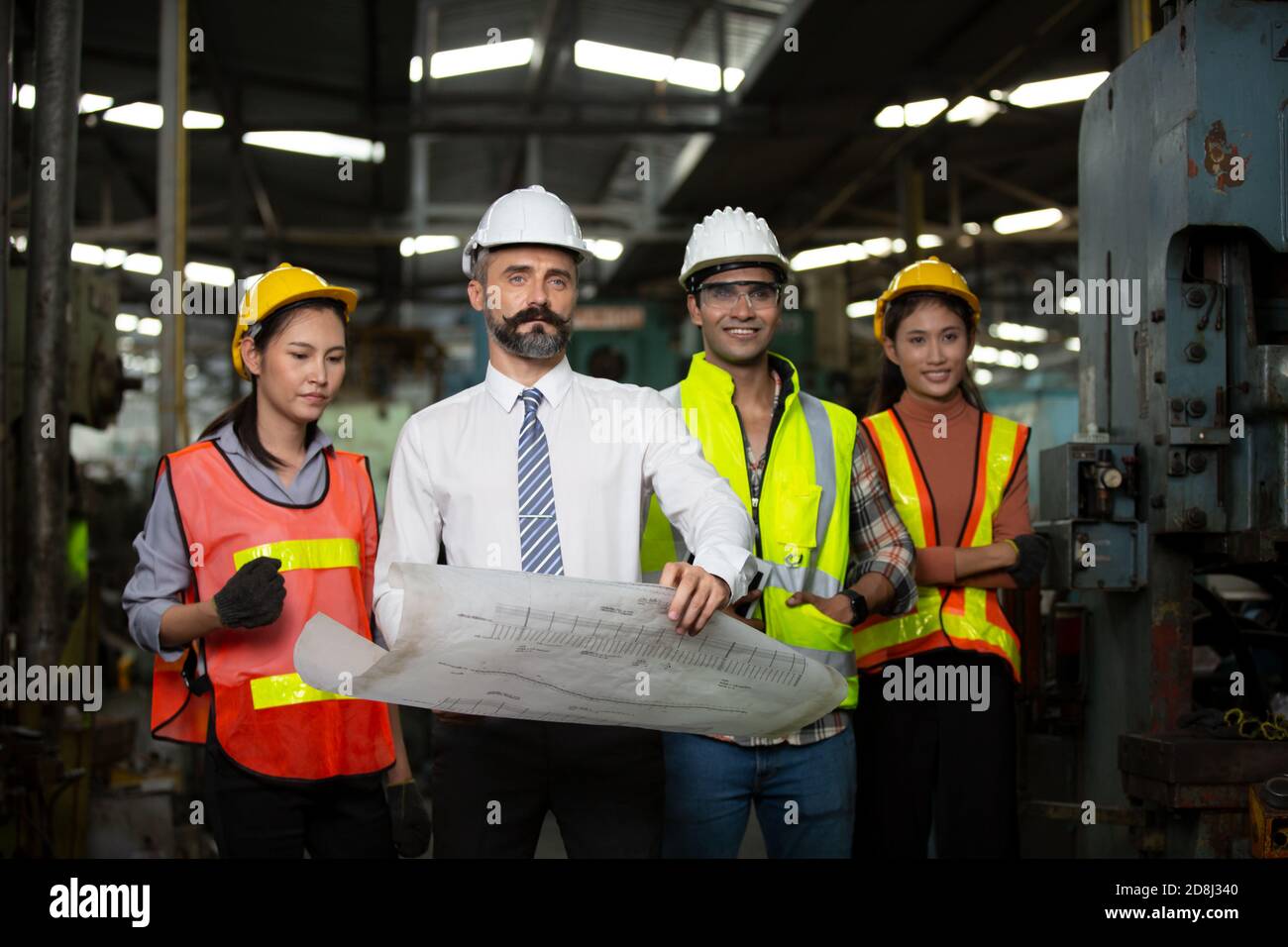 Male Industrial Engineers Talk with Factory Worker . They Work at the ...
