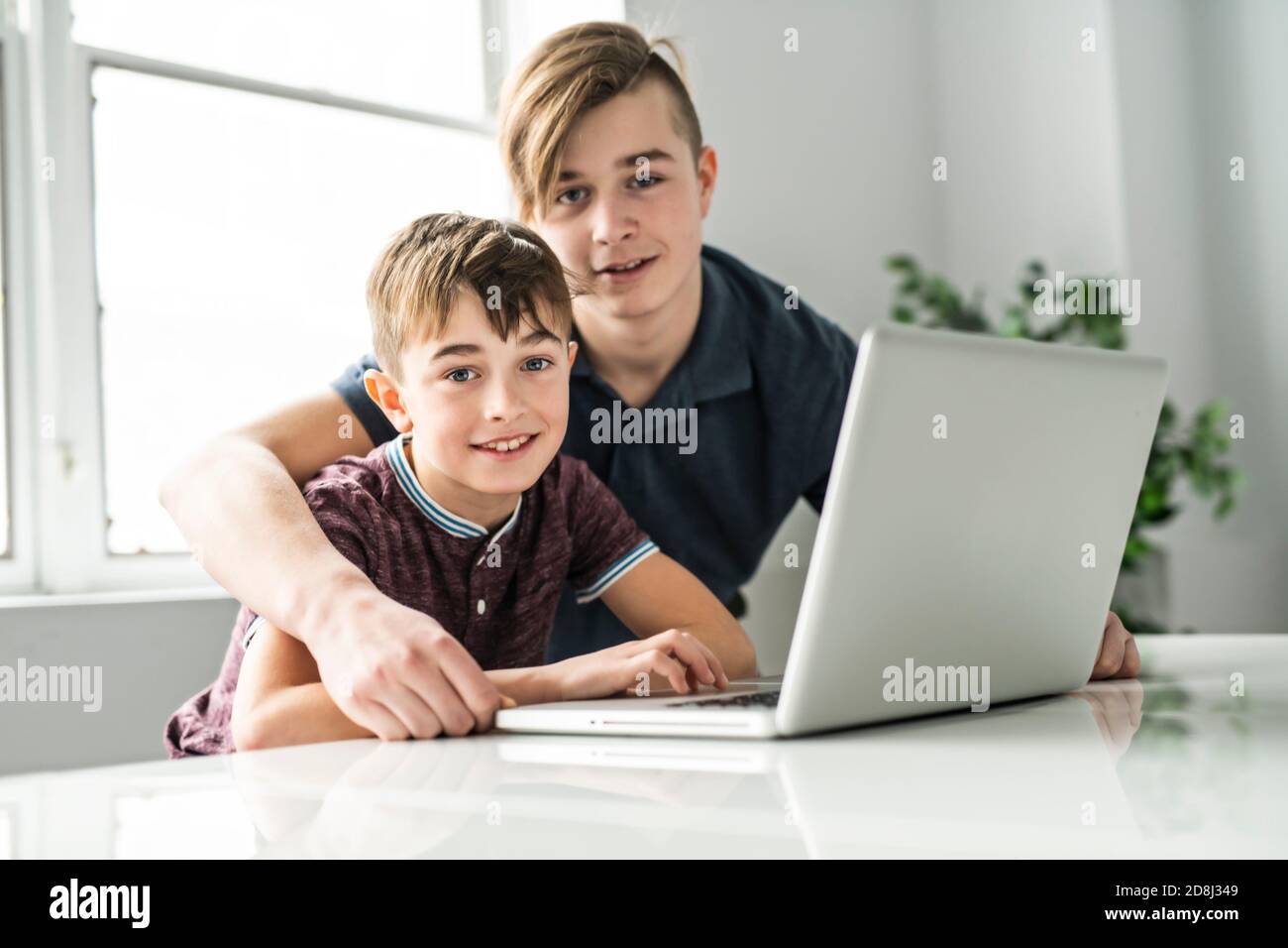 Two boys using laptop school hi-res stock photography and images - Alamy
