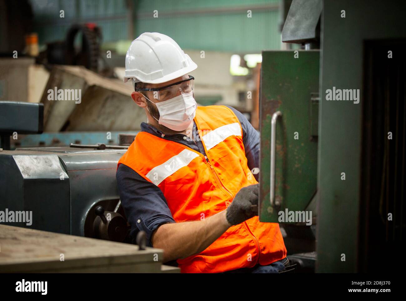 Engineers operating a cnc machine in factory Stock Photo - Alamy
