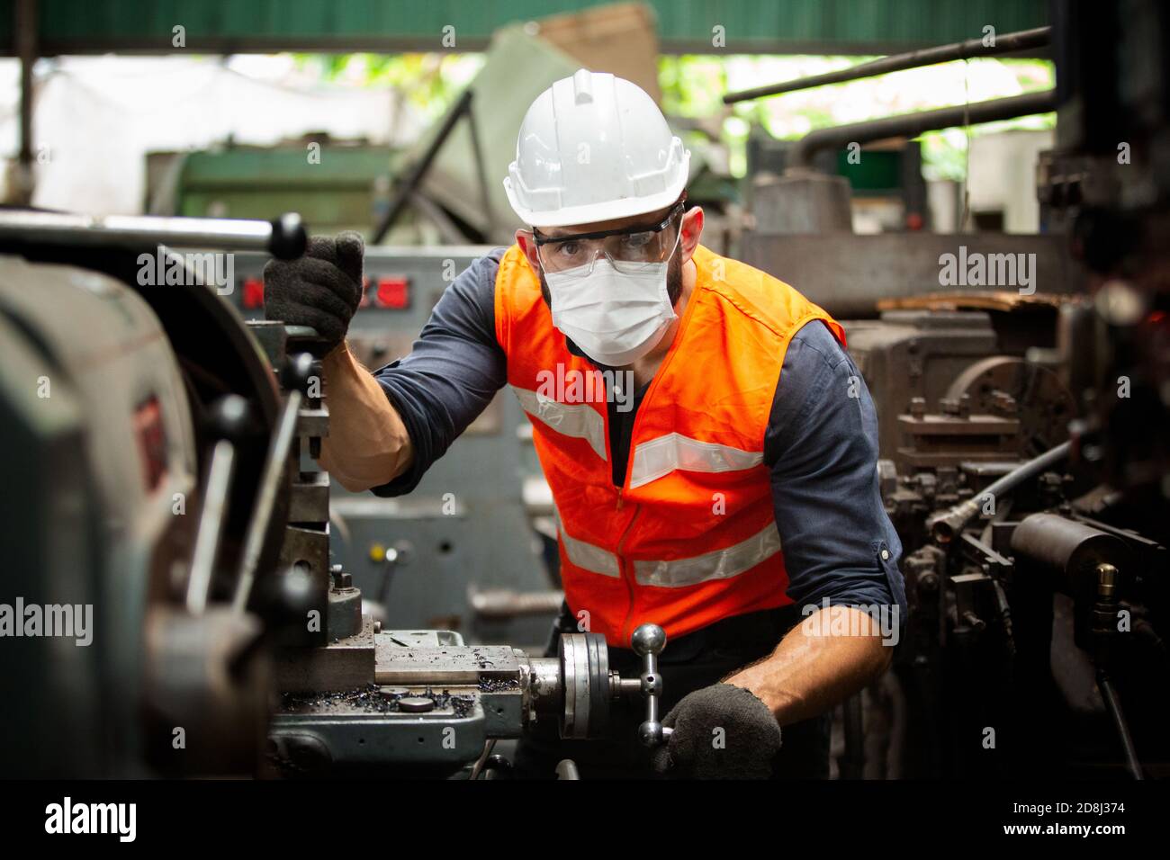 Engineers operating a cnc machine in factory Stock Photo - Alamy