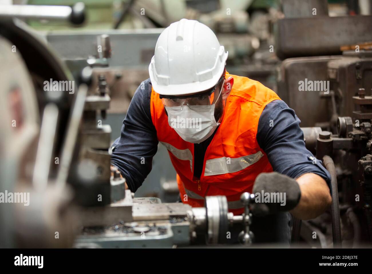 Engineers operating a cnc machine in factory Stock Photo - Alamy