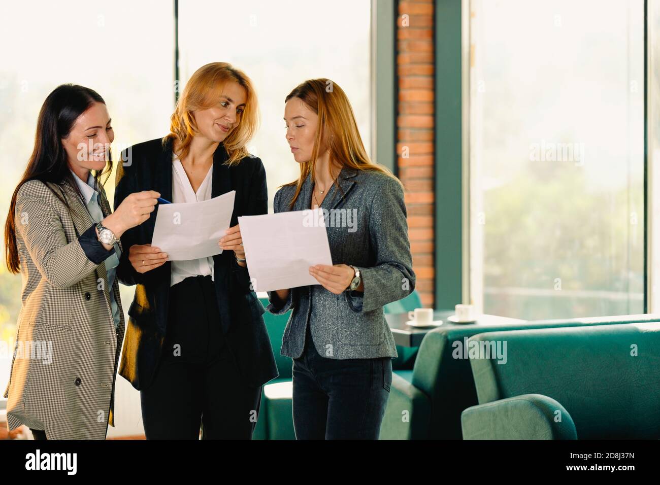 Female colleagues, young business women in a modern office are ...