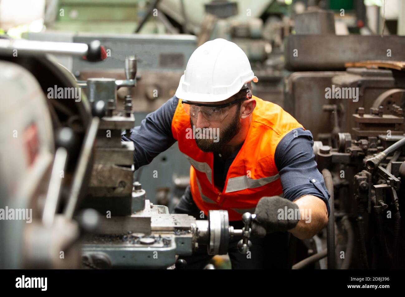 Engineers operating a cnc machine in factory Stock Photo - Alamy