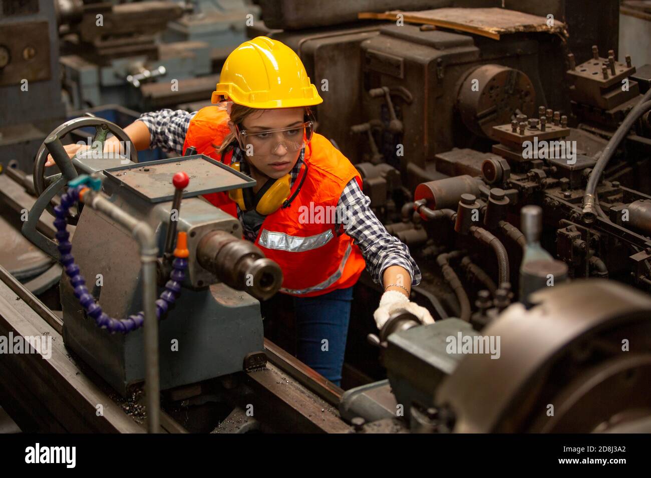 Female Engineers operating a cnc machine in factory Stock Photo - Alamy