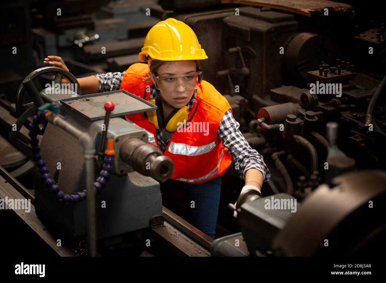 Female Engineers operating a cnc machine in factory Stock Photo - Alamy