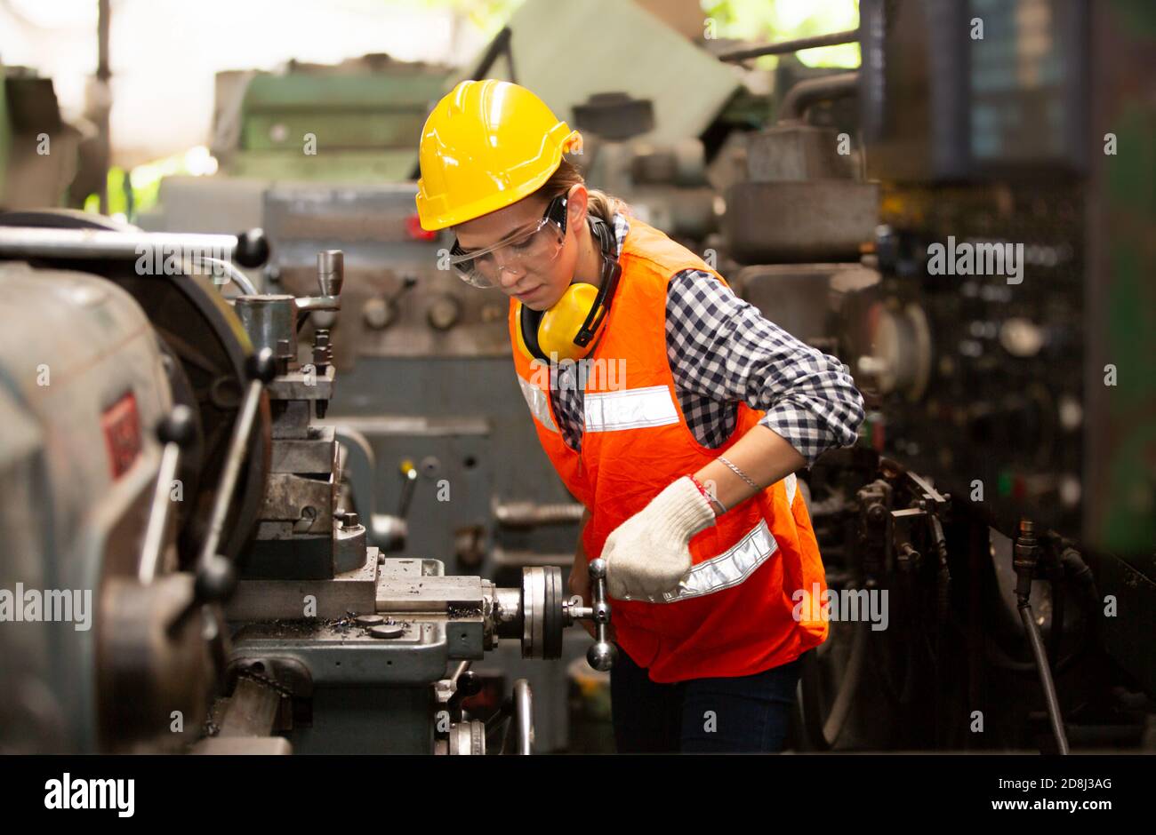 Female Engineers operating a cnc machine in factory Stock Photo - Alamy