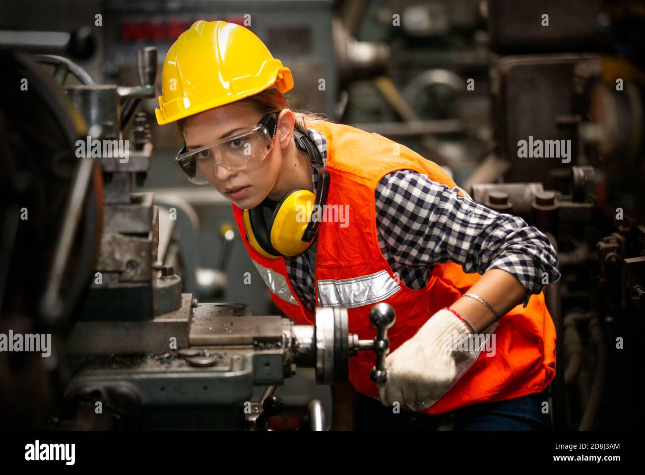 Female Engineers operating a cnc machine in factory Stock Photo - Alamy
