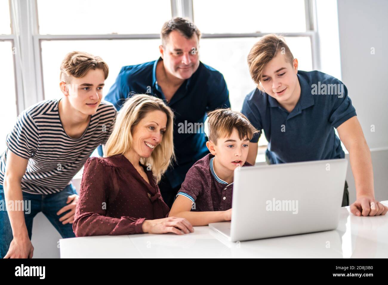 big family looking in computer at home Stock Photo - Alamy