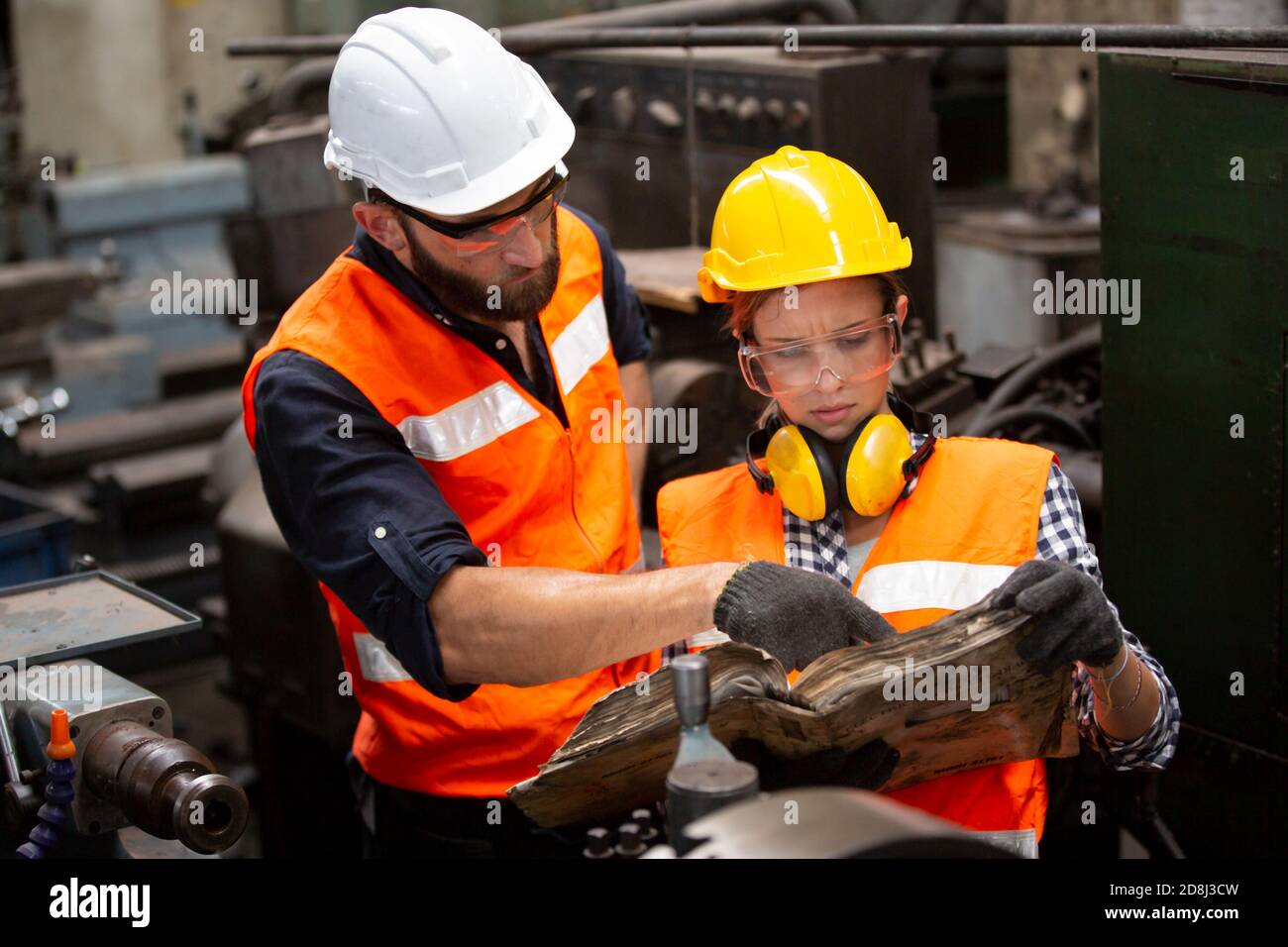 Engineers operating a cnc machine in factory Stock Photo - Alamy