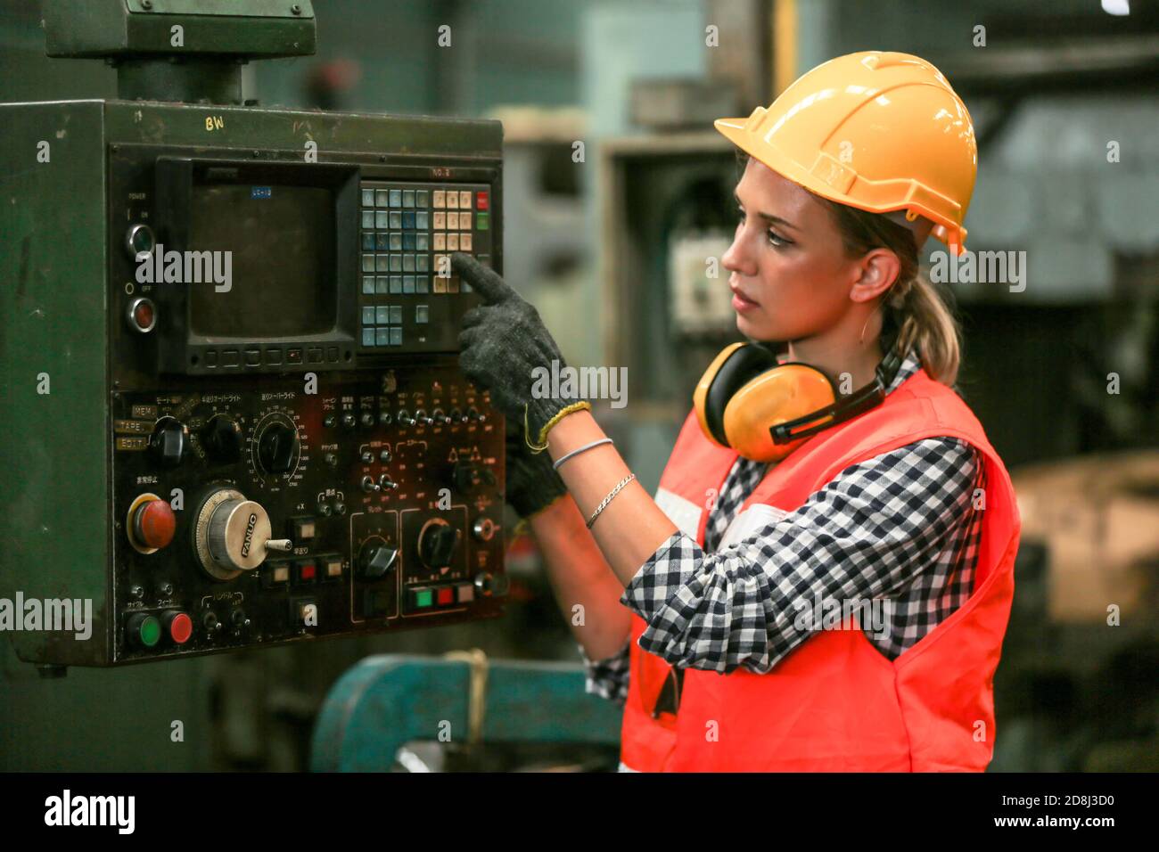 Female Engineers operating a cnc machine in factory Stock Photo - Alamy