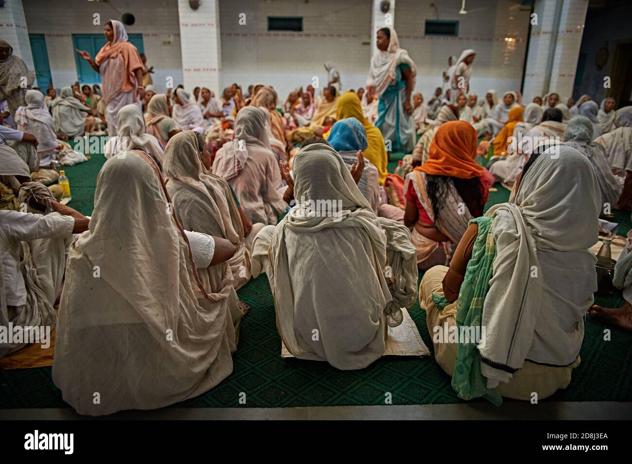Vrindavan, India, August 2009. Widows gathered to pray inside an ashram ...