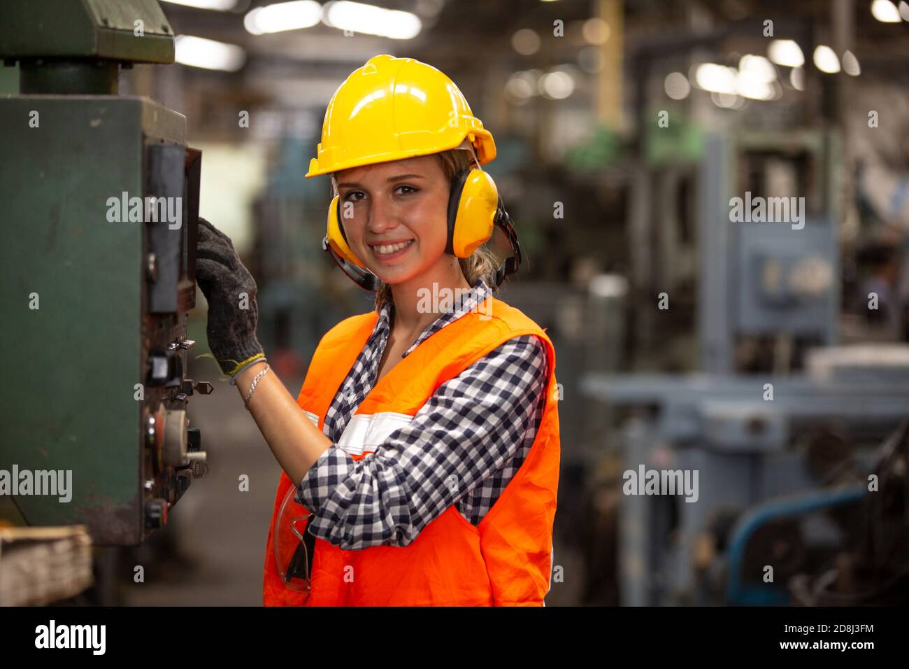 Female Engineers operating a cnc machine in factory Stock Photo - Alamy
