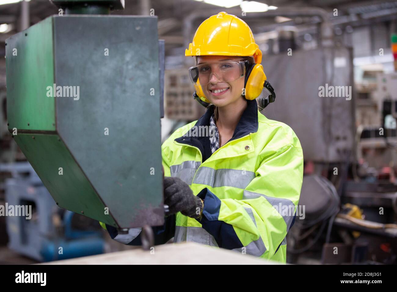 Female Engineers operating a cnc machine in factory Stock Photo - Alamy