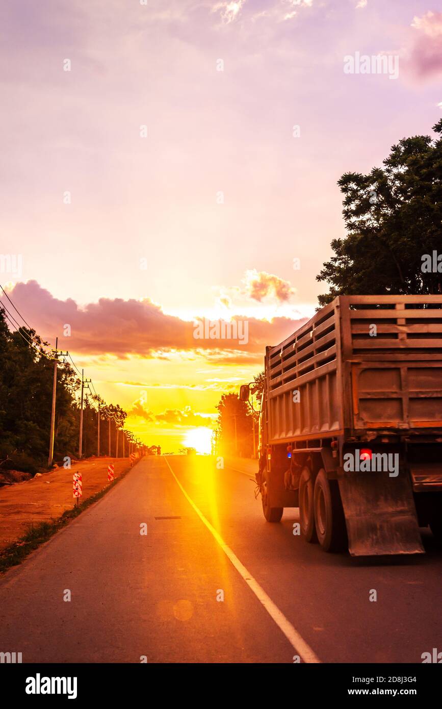 Truck on road with colorful of sunset or sunrise in twilight Stock ...