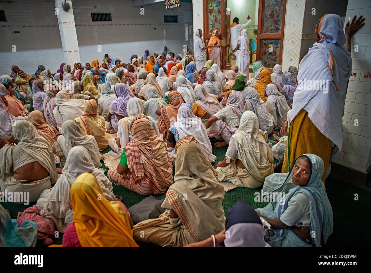 Vrindavan, India, August 2009. Widows gathered to pray inside an ashram ...