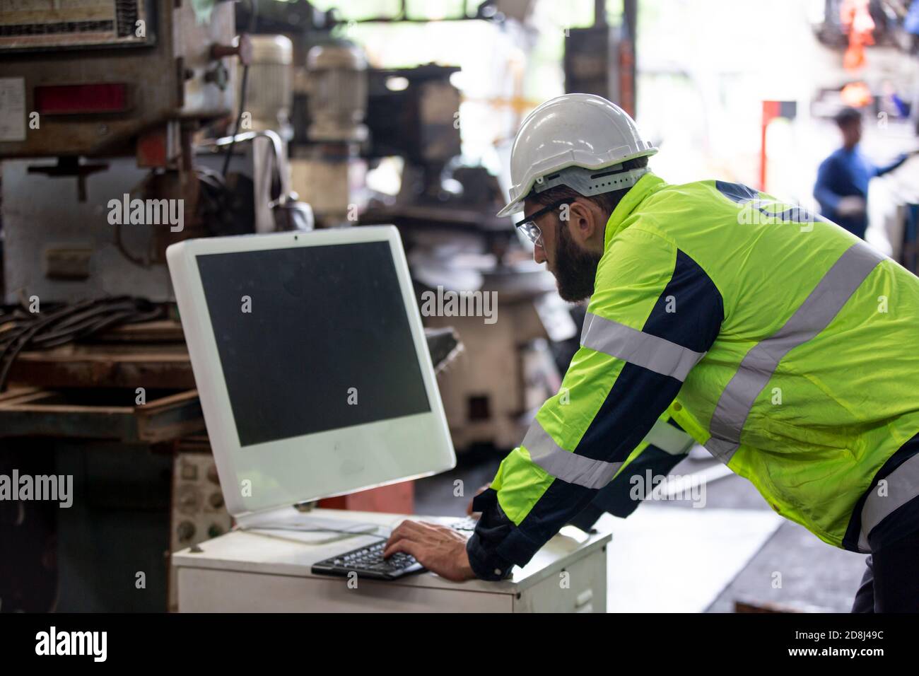 construction worker using laptop, Engineer standing with confident ...