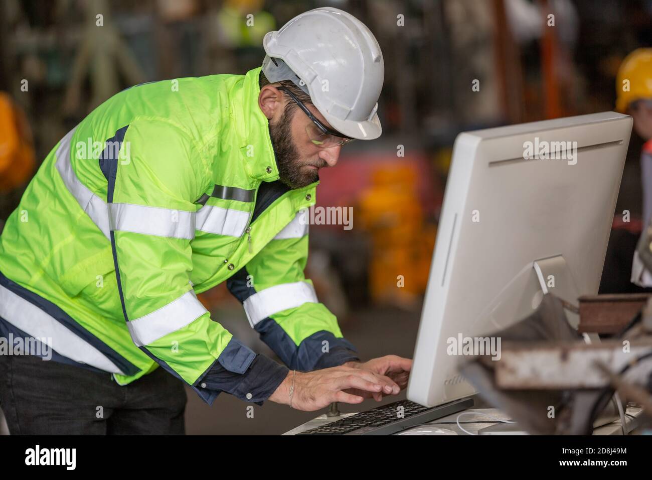 construction worker using laptop, Engineer standing with confident ...