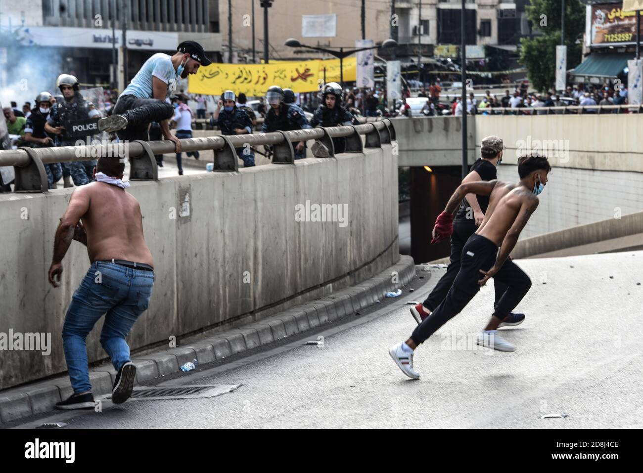 Beirut, Lebanon, 30 October 2020. Leaping a highway barrier to escape ...