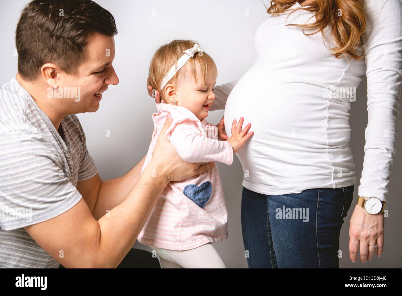 beautiful child girl touch the mother belly Stock Photo - Alamy
