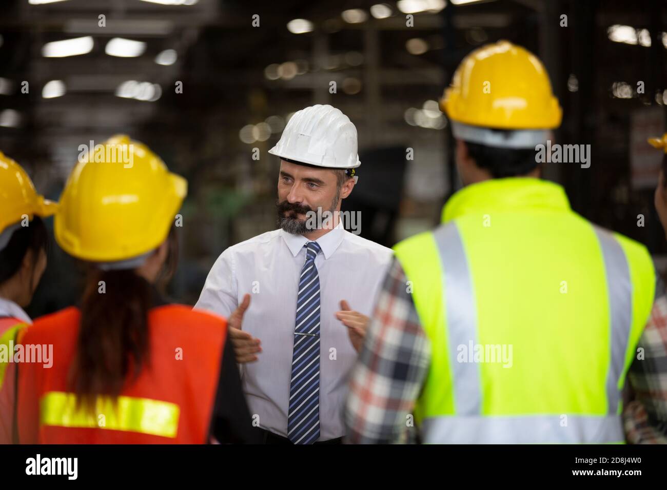 Male Industrial Engineers Talk with Factory Worker . They Work at the ...