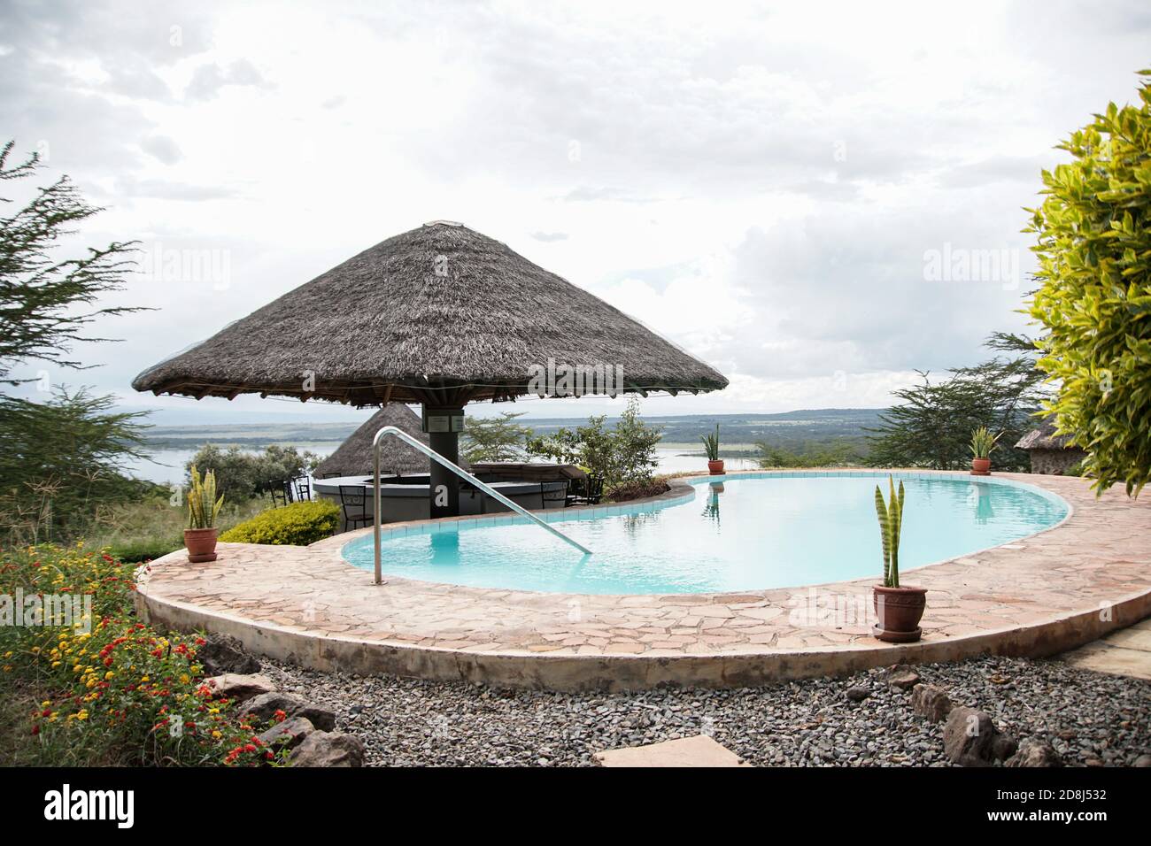 Umbrella and chair beside a pool Stock Photo - Alamy