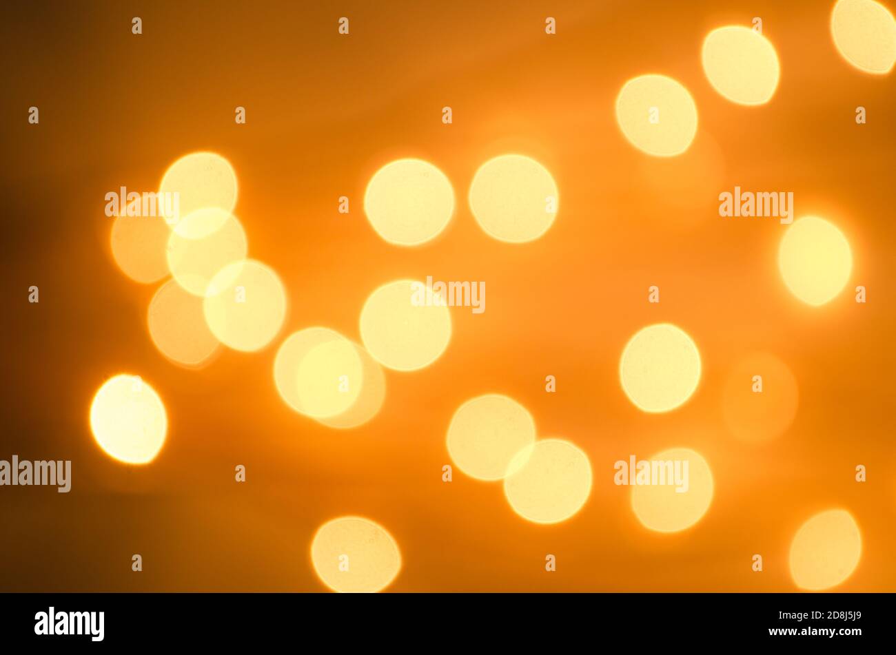 Golden lights in random pattern defocused to create blurred background ...