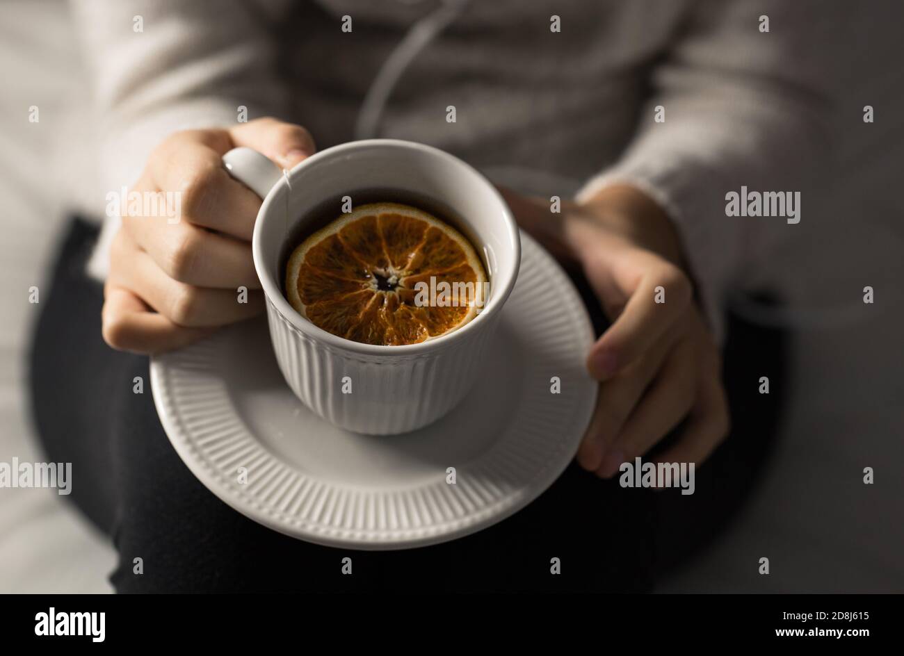 Detail of woman's hands holding a cup of tea seen from above Stock ...