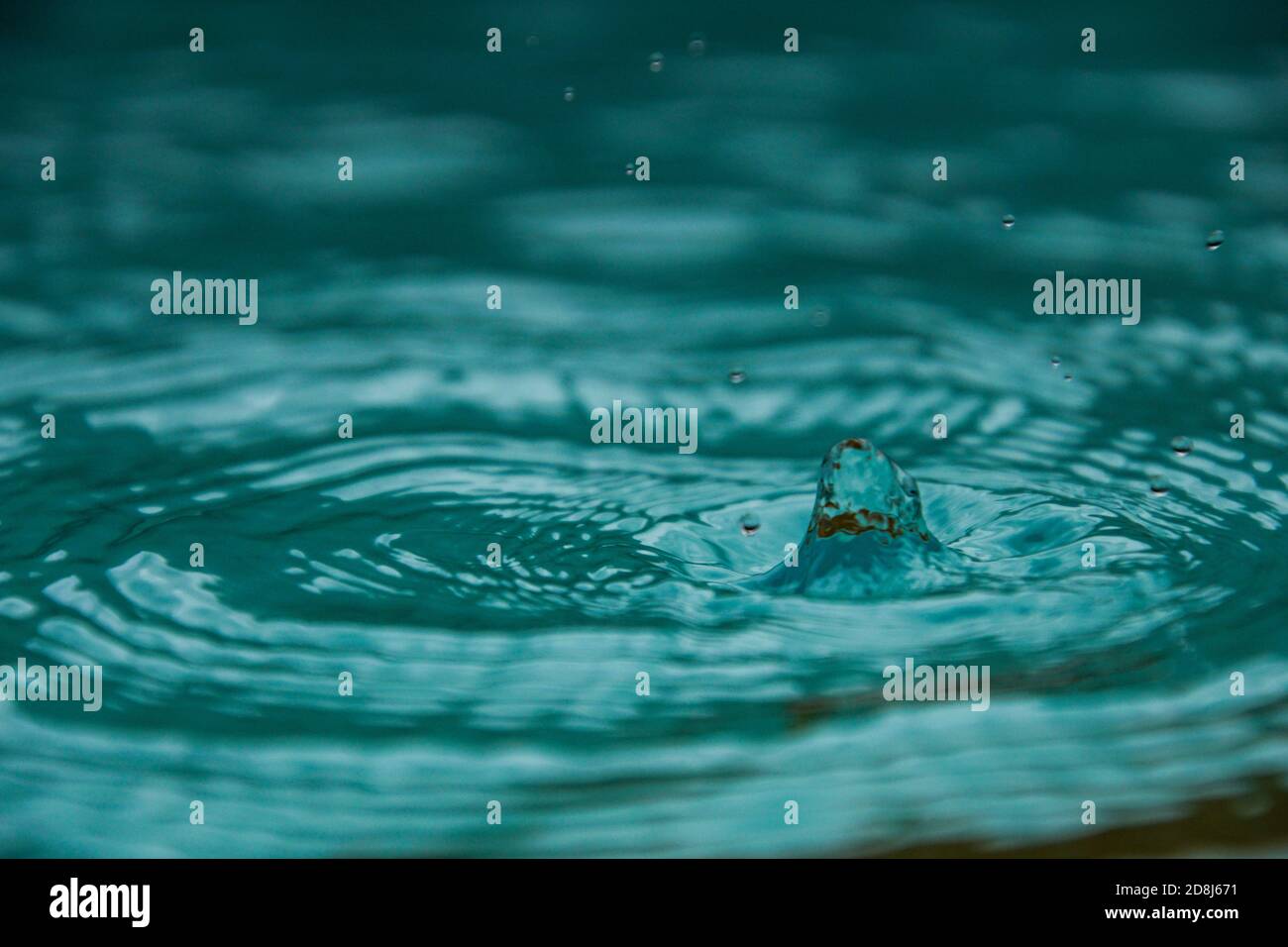 Water drop in water Stock Photo - Alamy