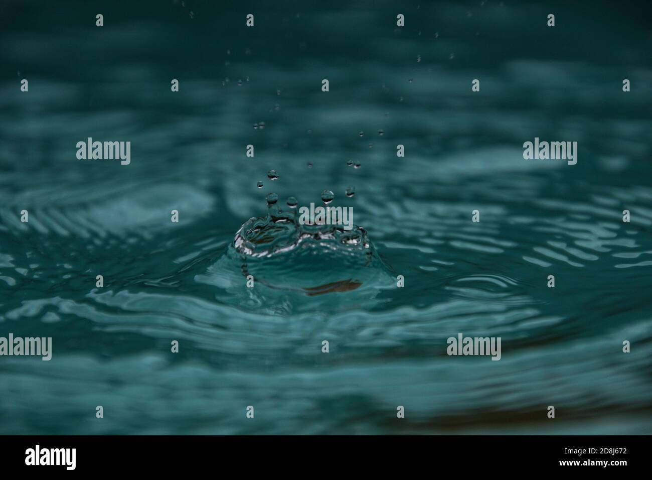 Water drop in water Stock Photo - Alamy