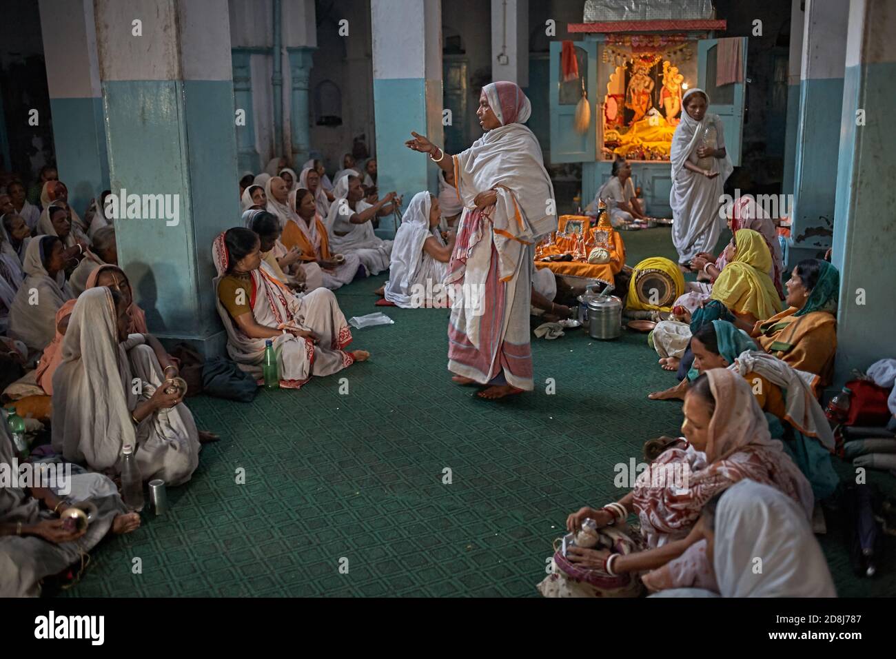 Vrindavan, India, August 2009. Widows gathered to pray inside an ashram ...