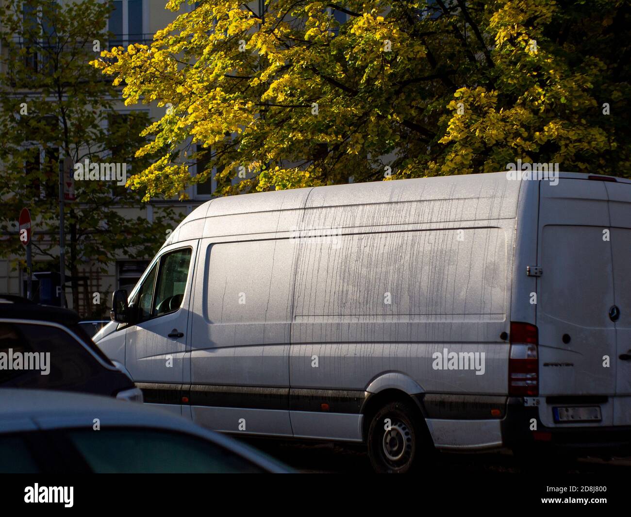 White van in the street in the morning sun Stock Photo - Alamy