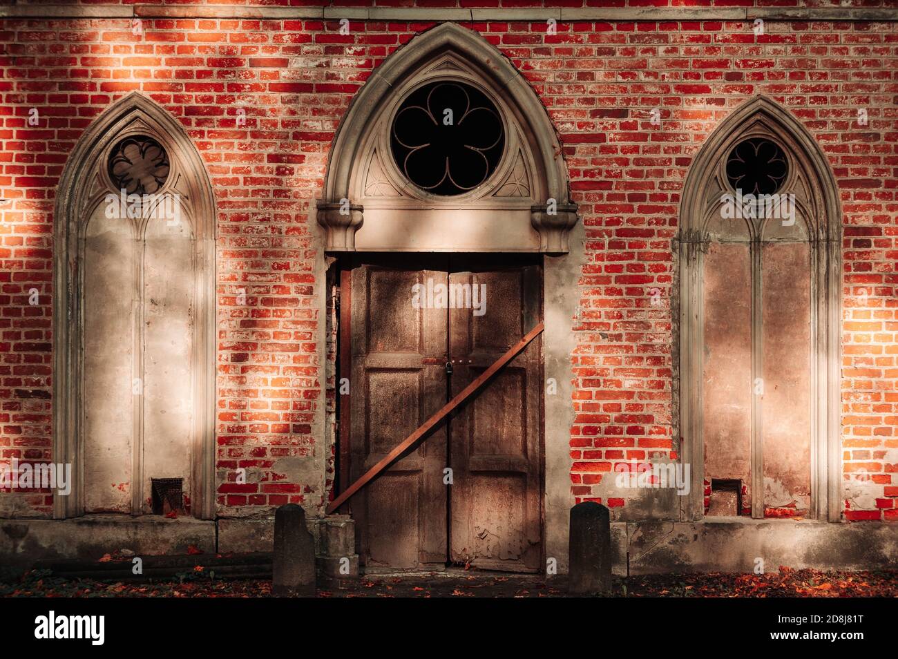 Abandoned Catholic parish. An ancient building with boarded up doors ...