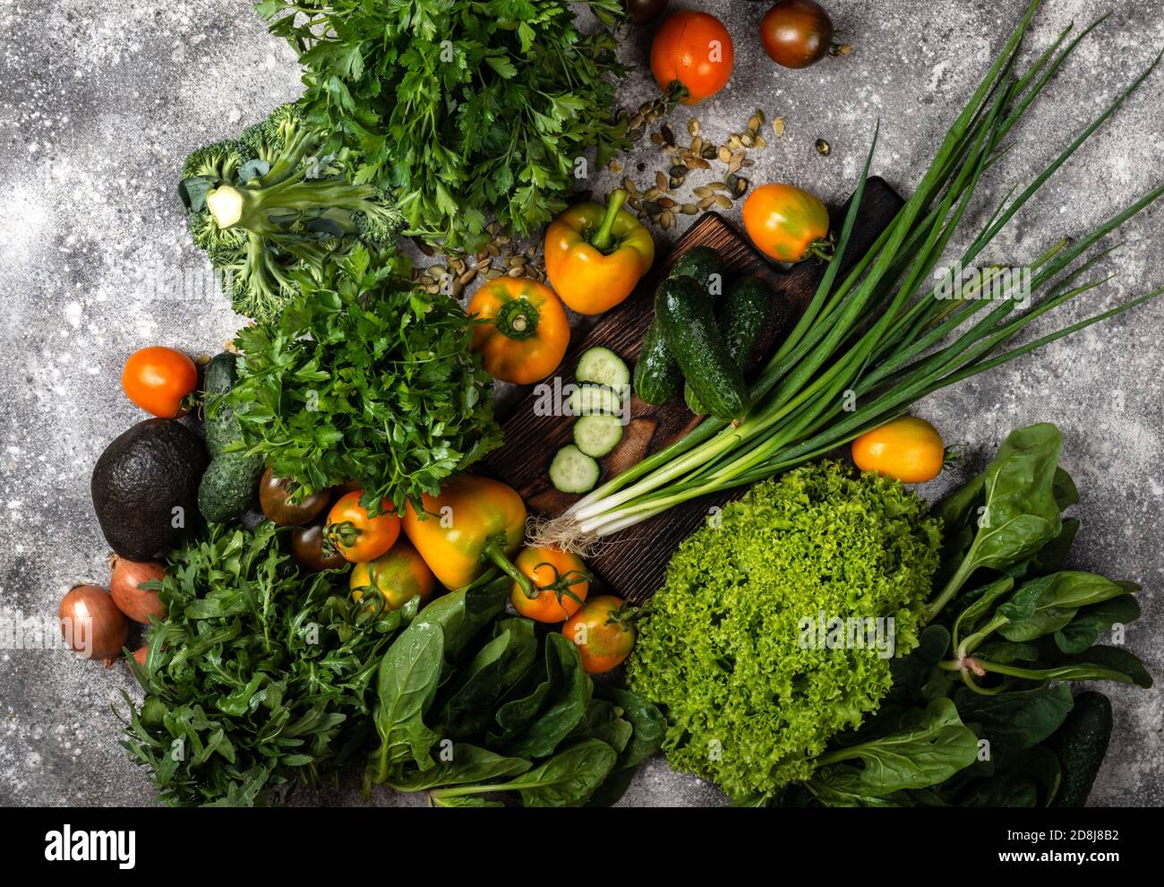 Vegan menu concept. Vegetables and greens with chopping board on the ...