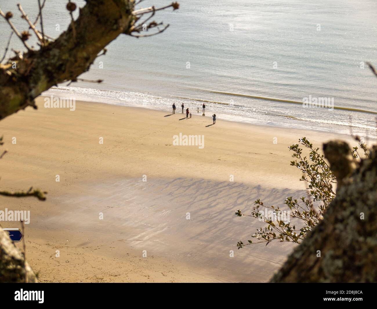 Beach scene with people in the distance Stock Photo - Alamy