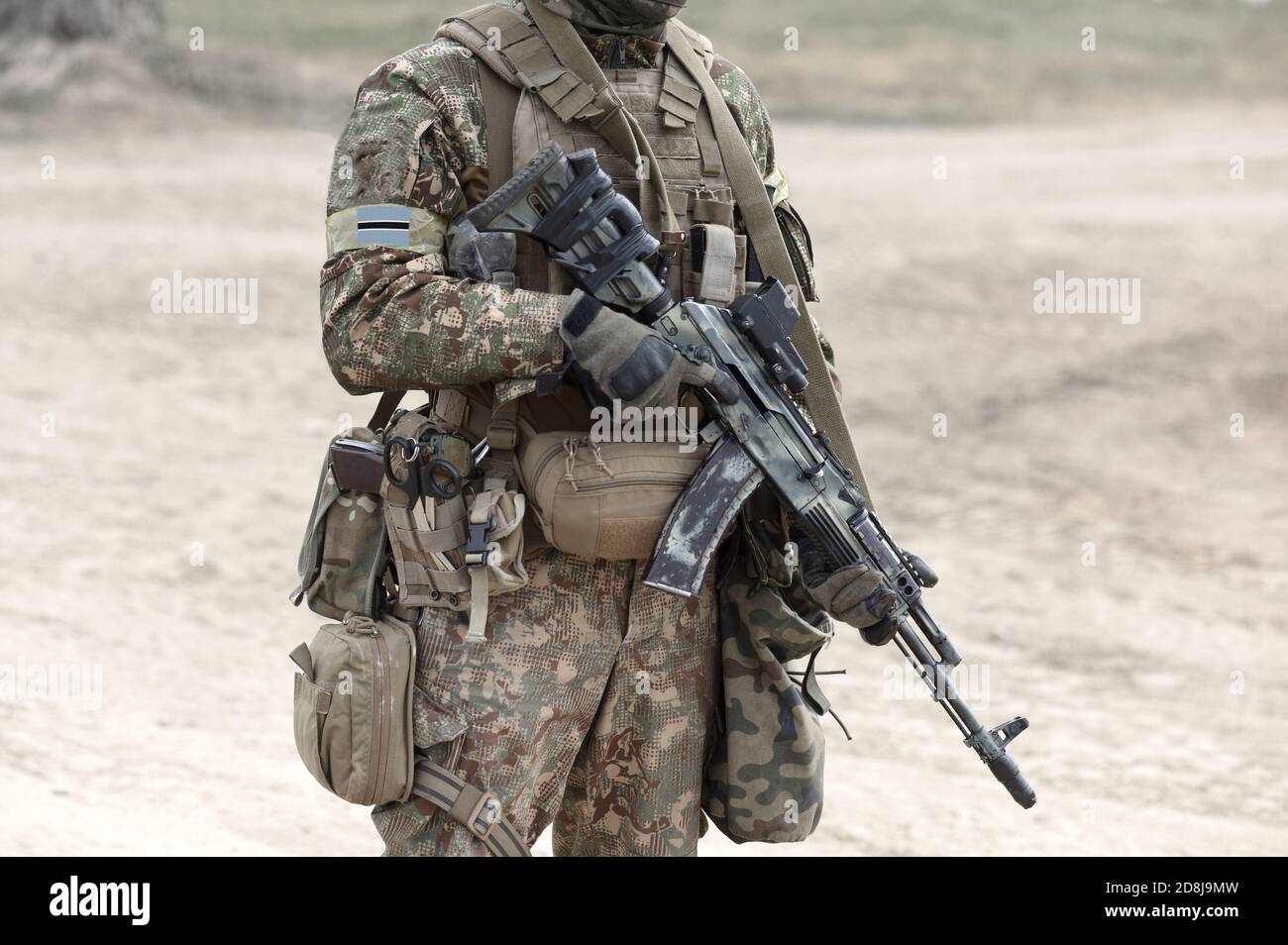 Soldier with assault rifle and flag of Botswana on military uniform ...