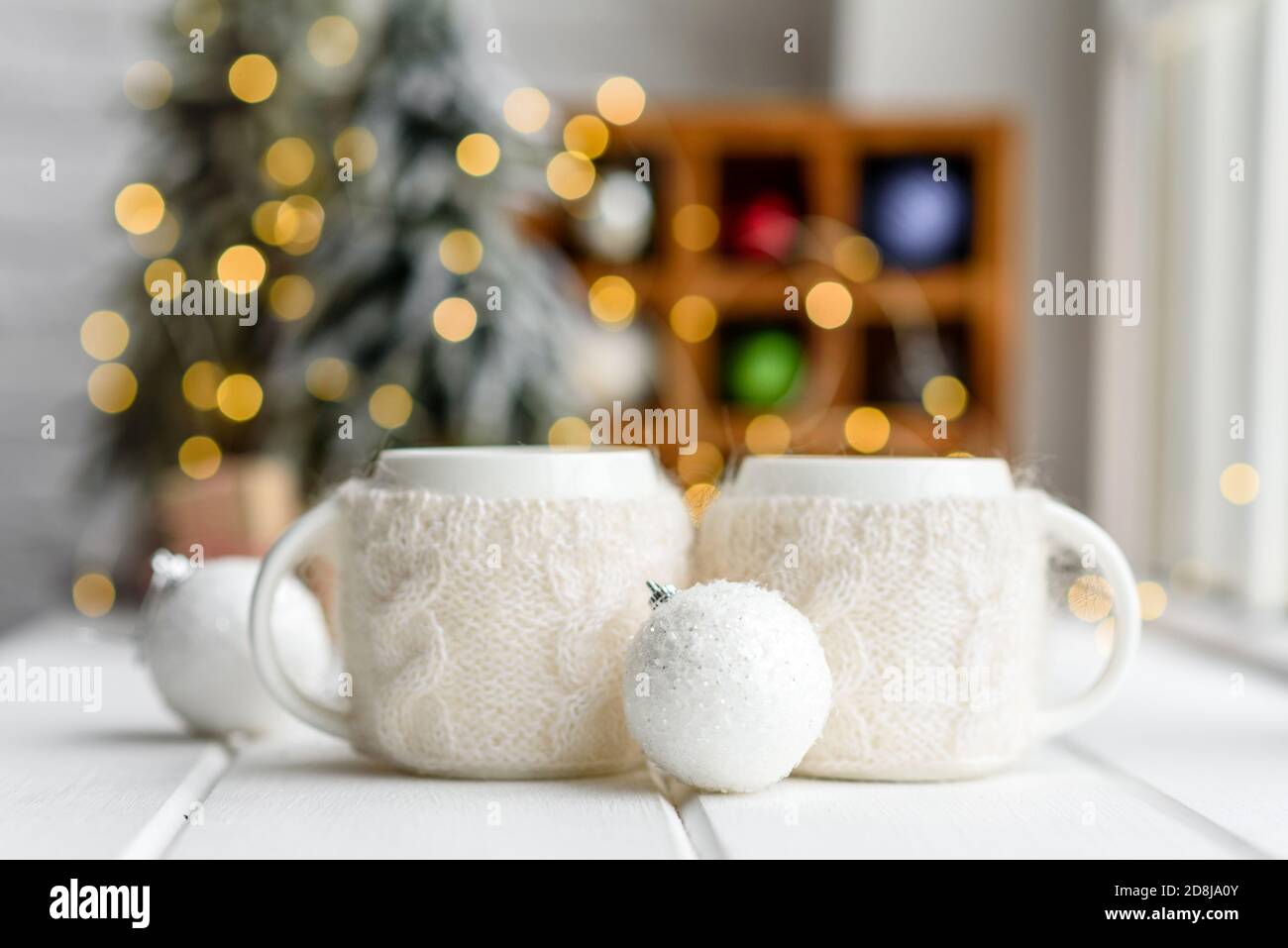 Beautiful multi-colored Christmas decorations on a light wooden table ...