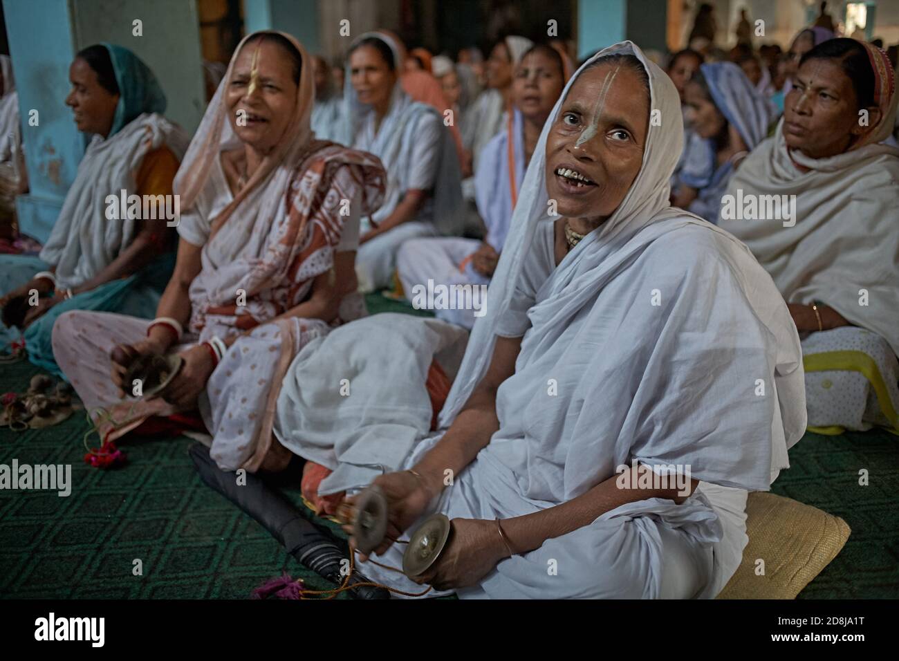 Vrindavan, India, August 2009. Widows gathered to pray inside an ashram ...