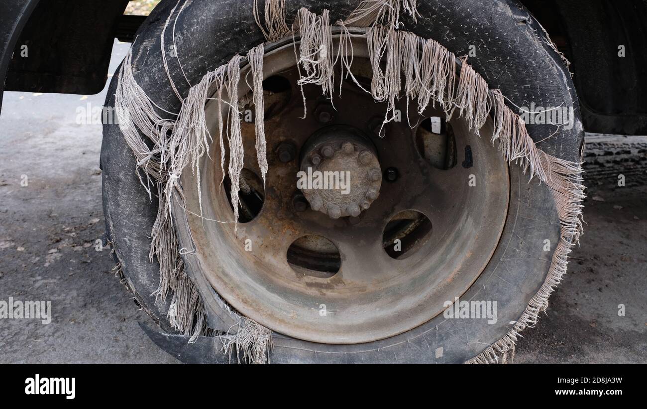 old worn tire on a car standing on a city street Stock Photo - Alamy