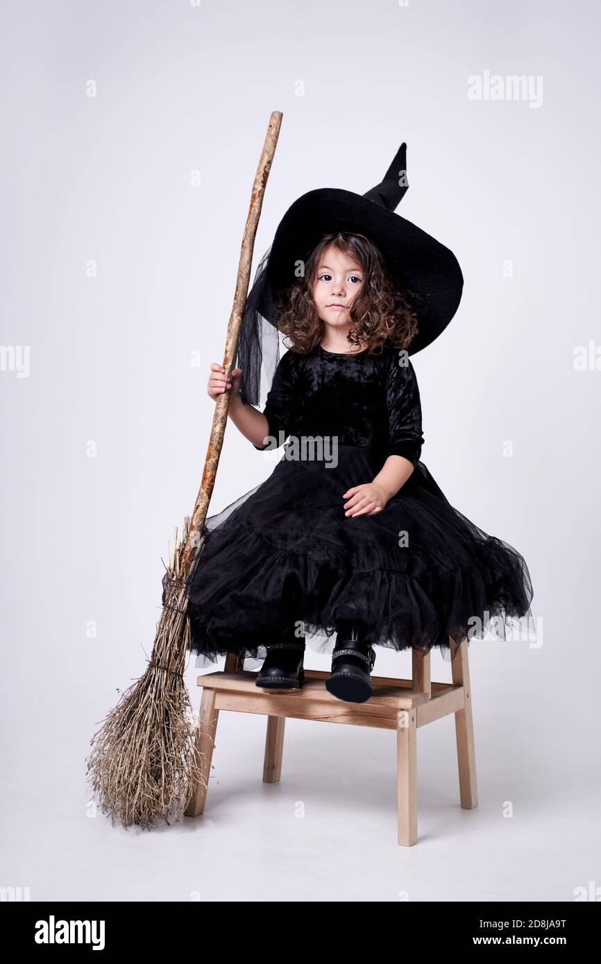 funny witch girl on white background with broom Stock Photo - Alamy