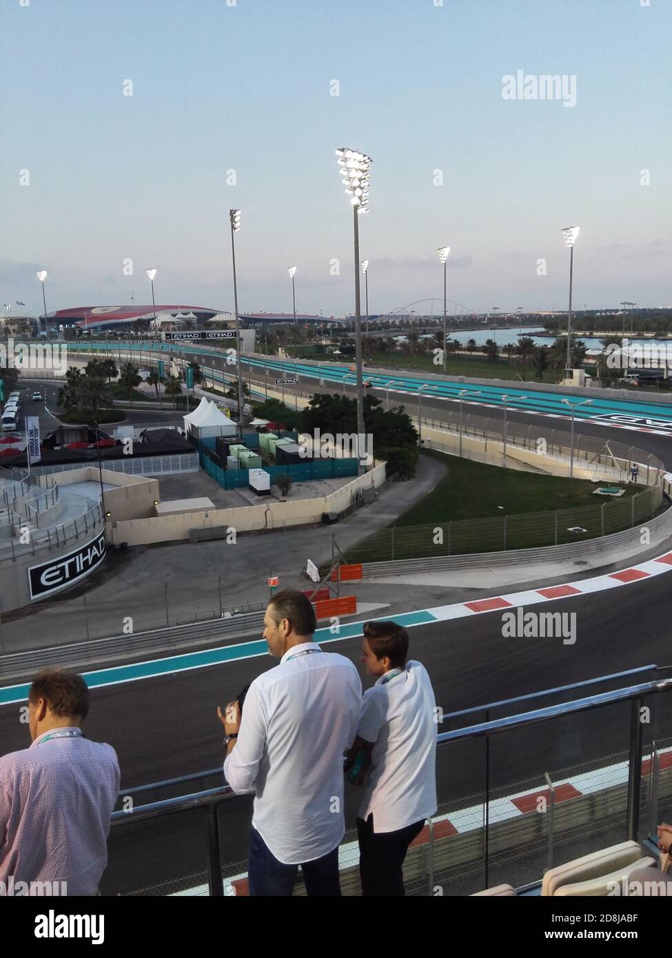 Three men watch the F1 races from above of the VIP tribune at Yas ...