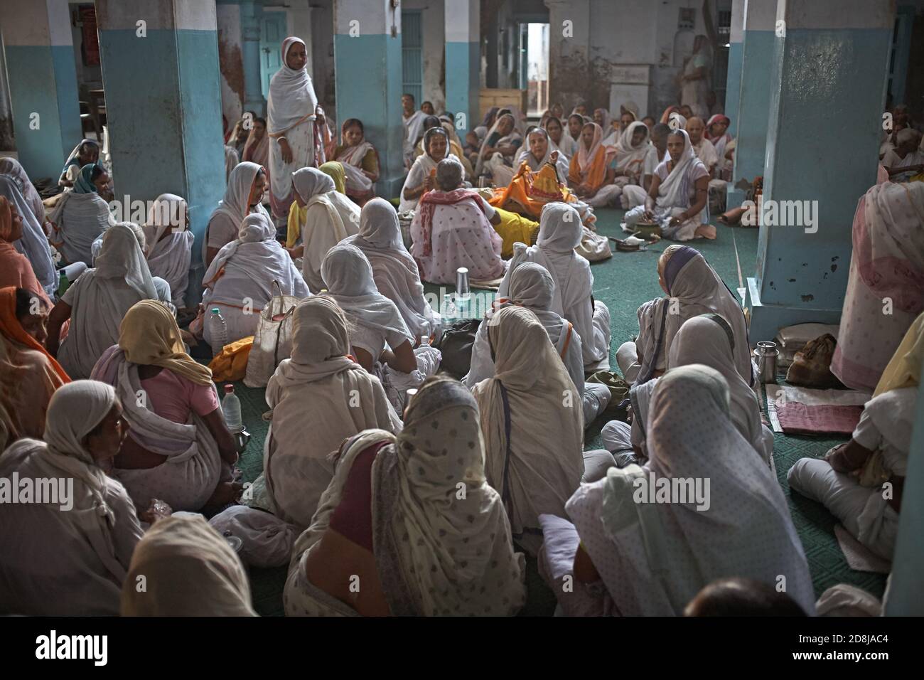 Vrindavan, India, August 2009. Widows gathered to pray inside an ashram ...
