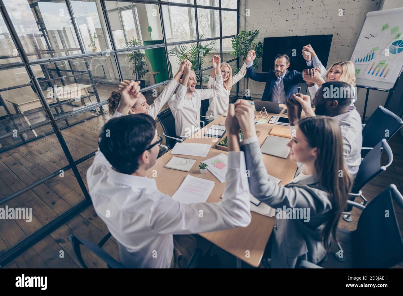 Nice stylish cheerful cheery managers staff gathering holding hands ...