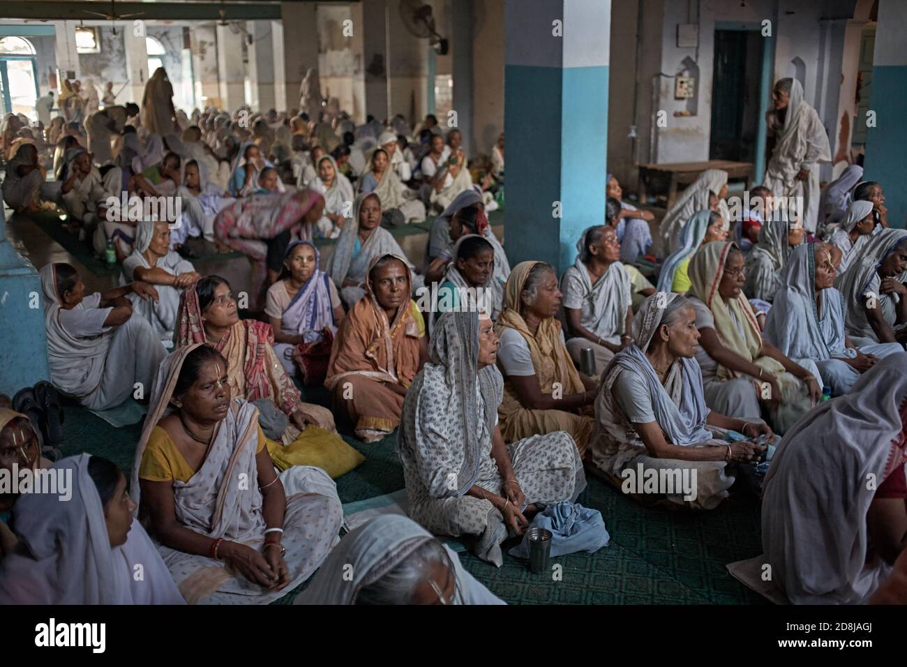 Vrindavan, India, August 2009. Widows gathered to pray inside an ashram ...