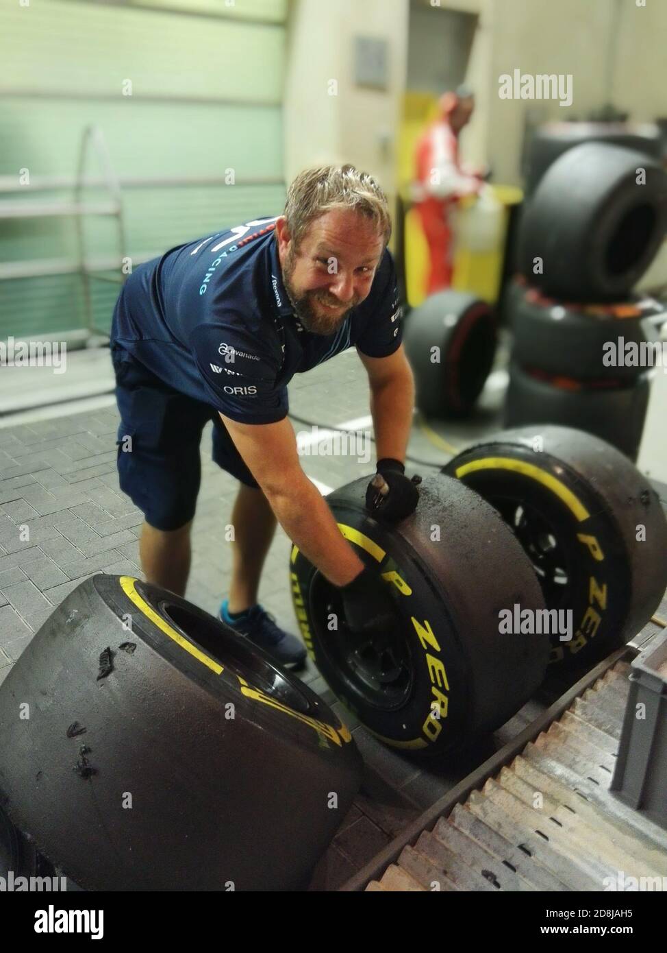 A technical team member handling the used racing wheels after the race ...
