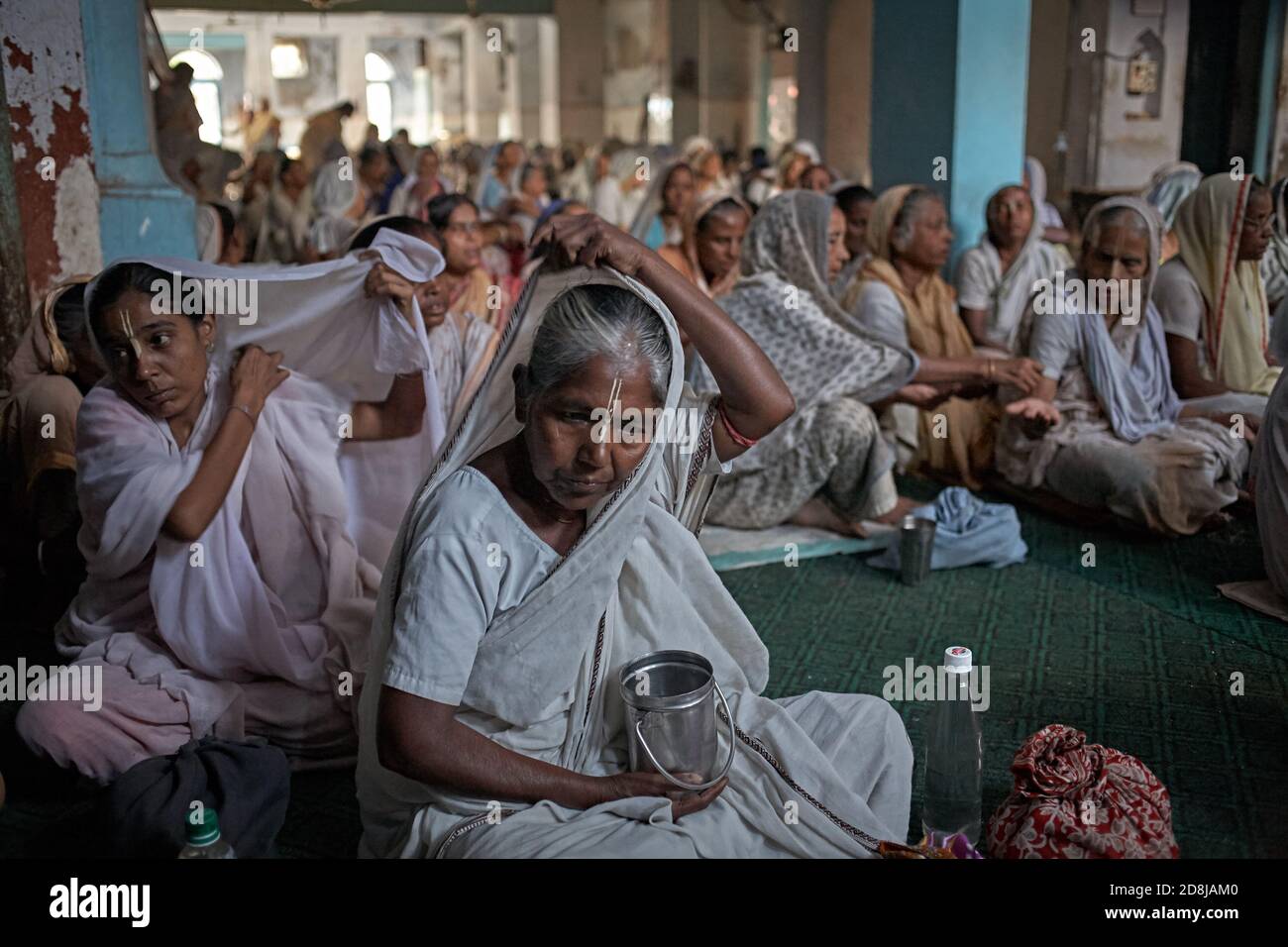 Vrindavan, India, August 2009. Widows gathered to pray inside an ashram ...